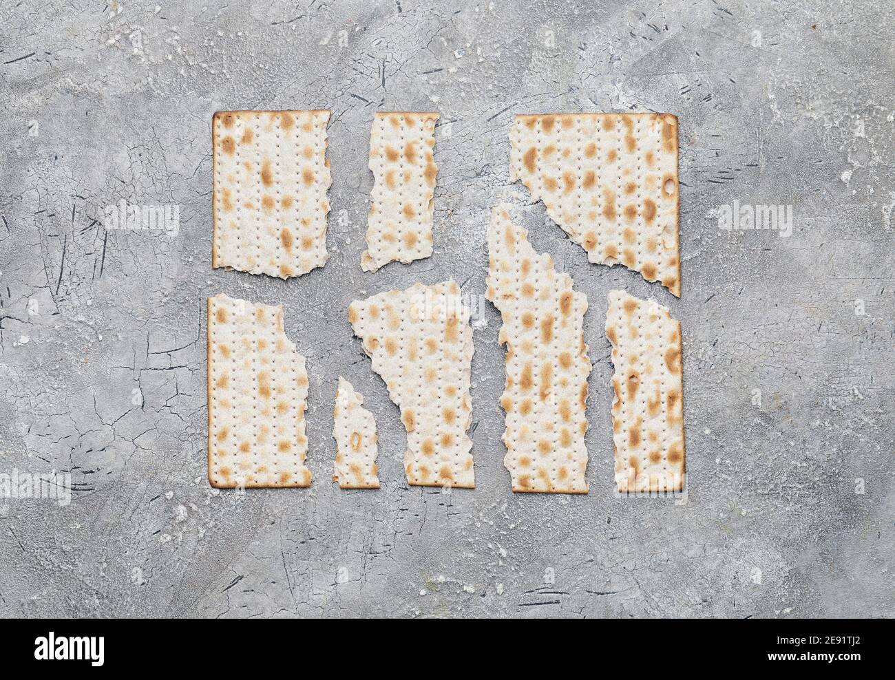 Broken Jewish flatbread matza for Passover on grey background Stock ...