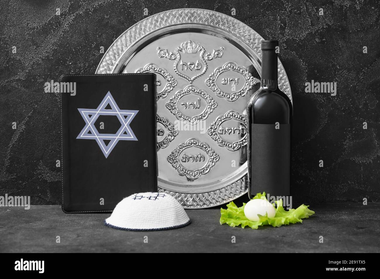Passover Seder plate with traditional food, wine, Jewish cap and Torah ...