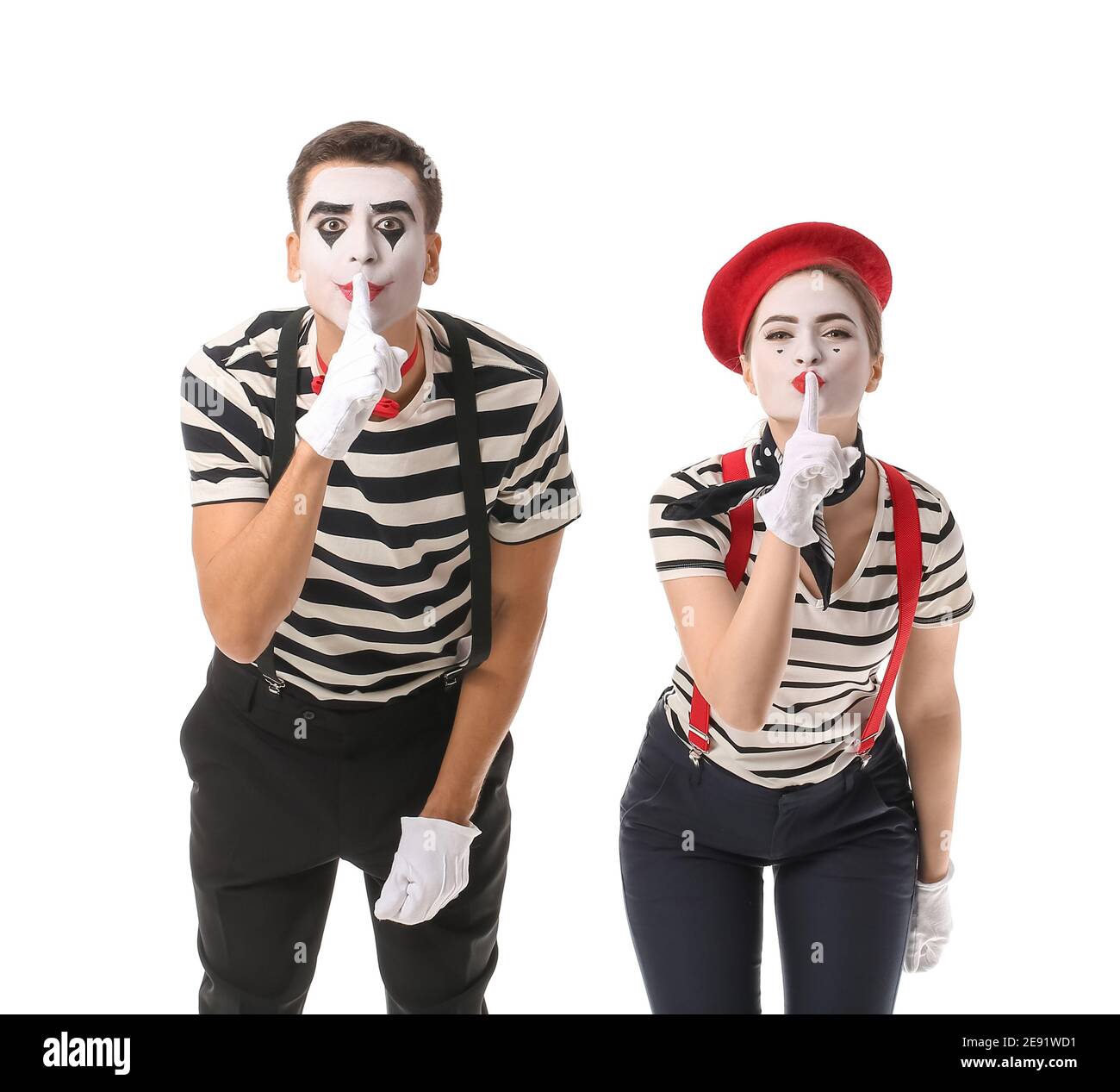 Male and female pantomimists showing silence gesture on white ...