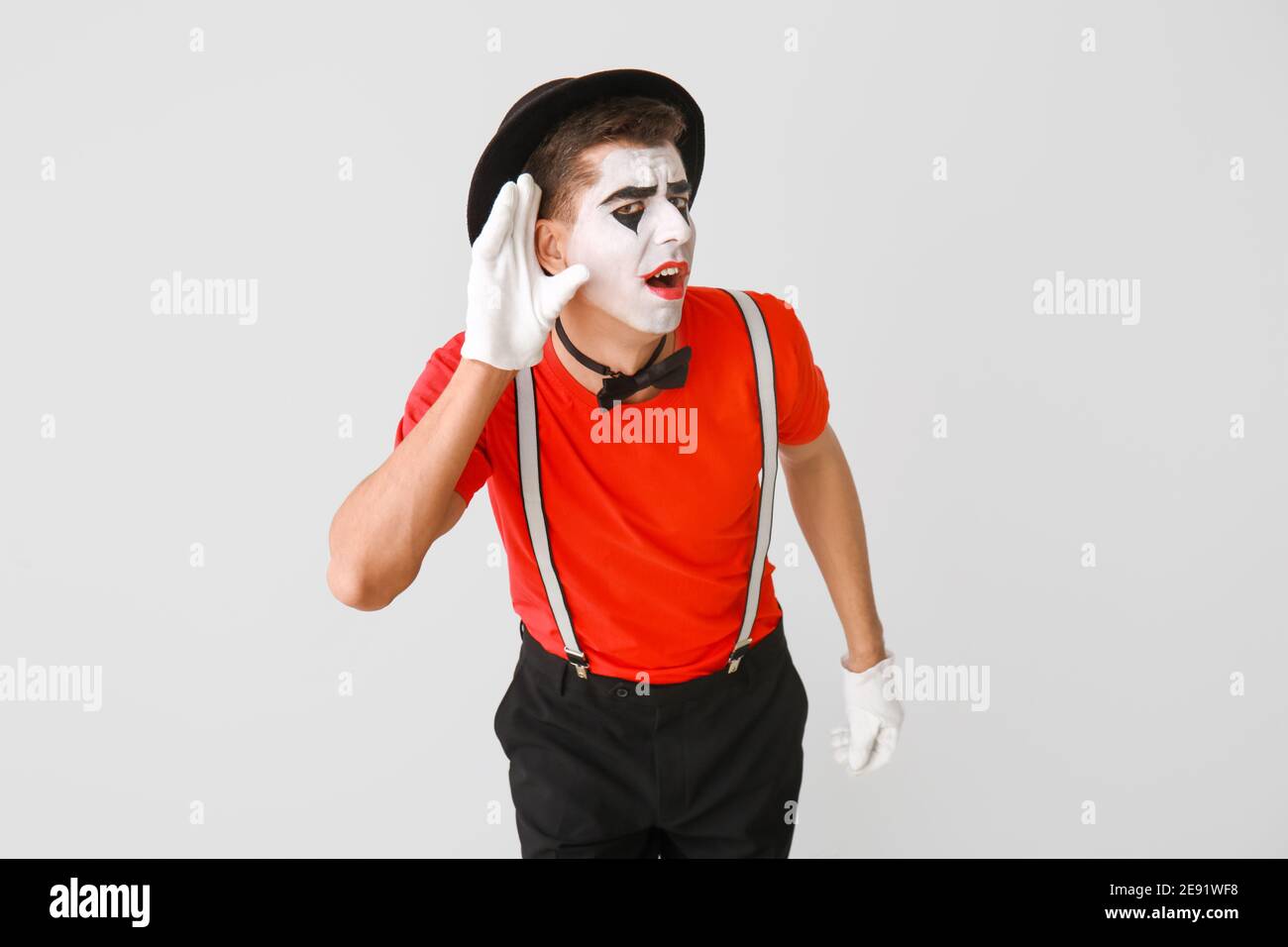 Male pantomimist on grey background Stock Photo - Alamy