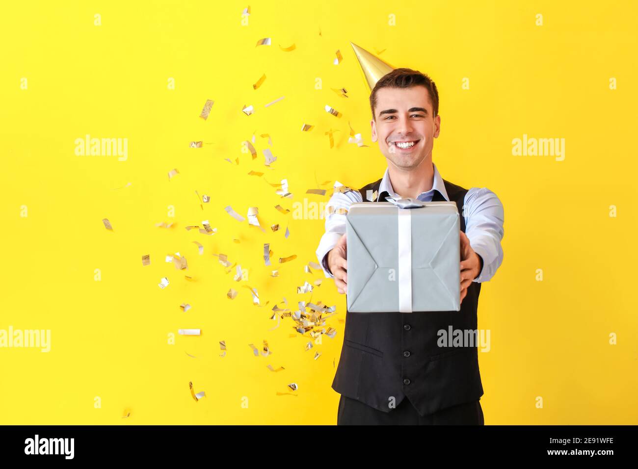 Happy man celebrating birthday on color background Stock Photo - Alamy