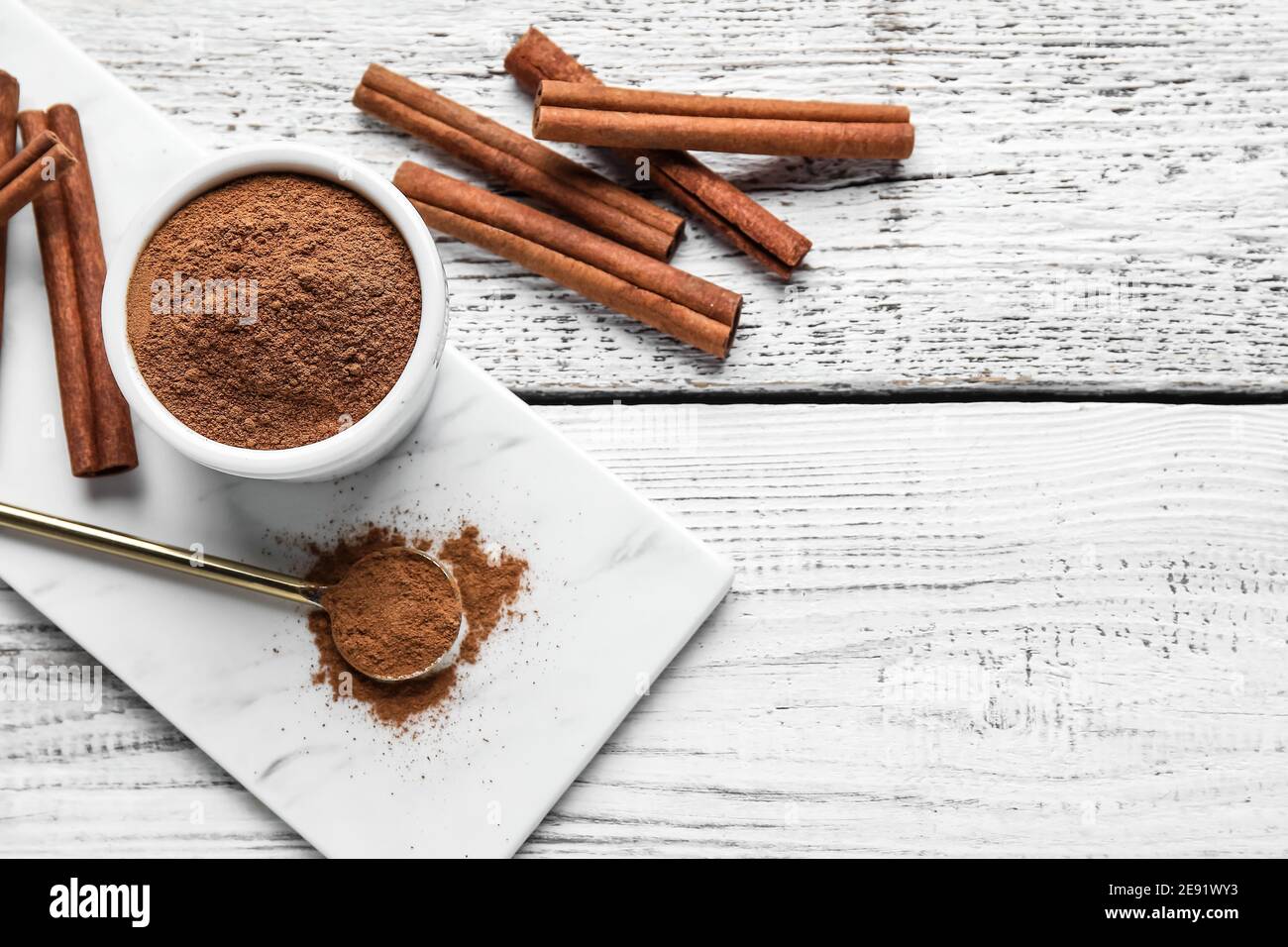 Cinnamon sticks and bowl with powder on wooden background Stock Photo ...