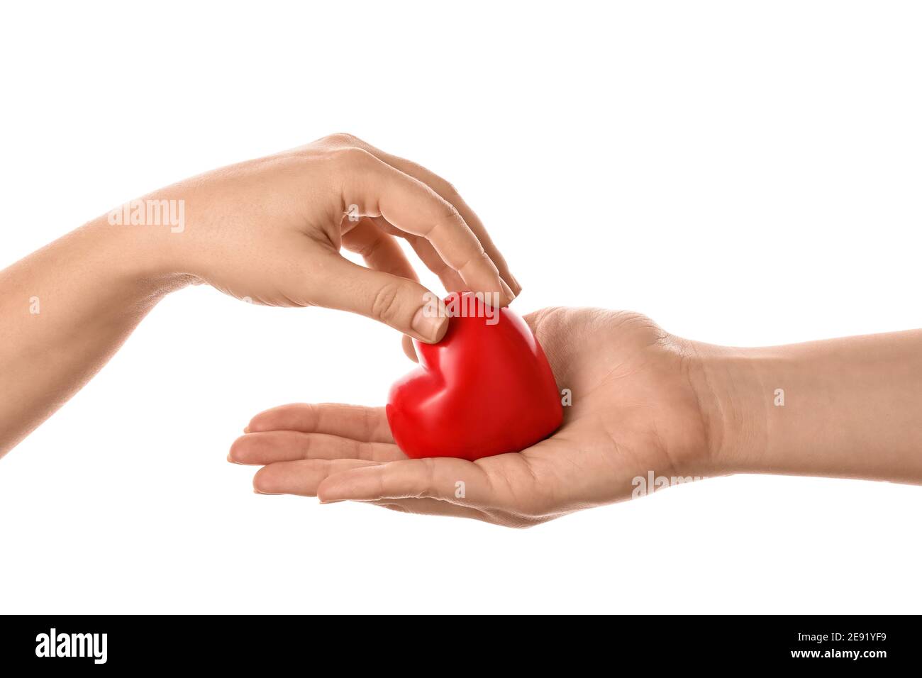 Hands with red heart on white background Stock Photo - Alamy
