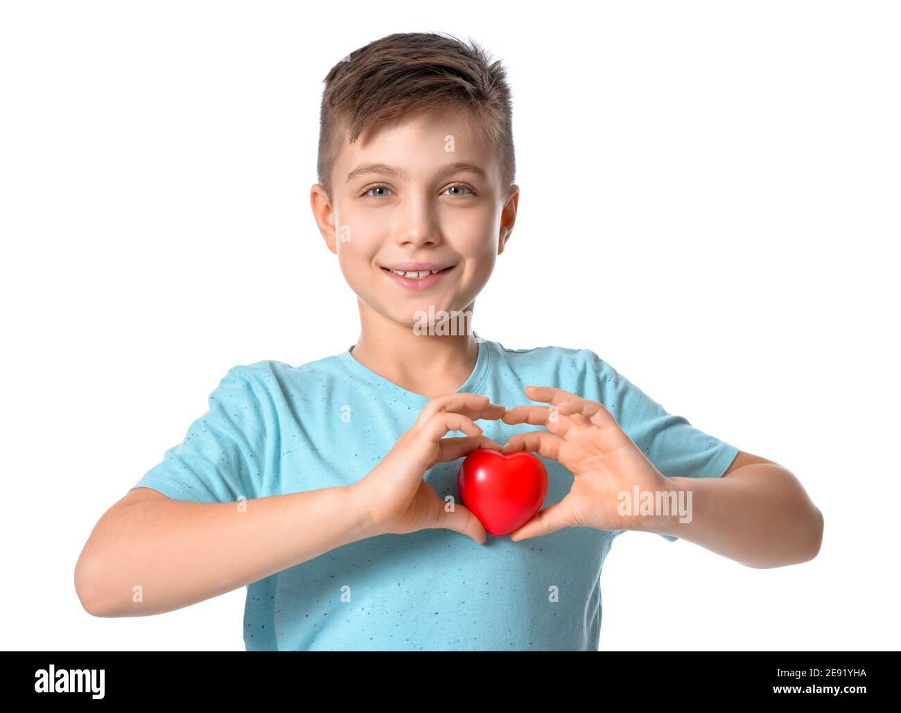 Cute little boy with red heart on white background Stock Photo - Alamy