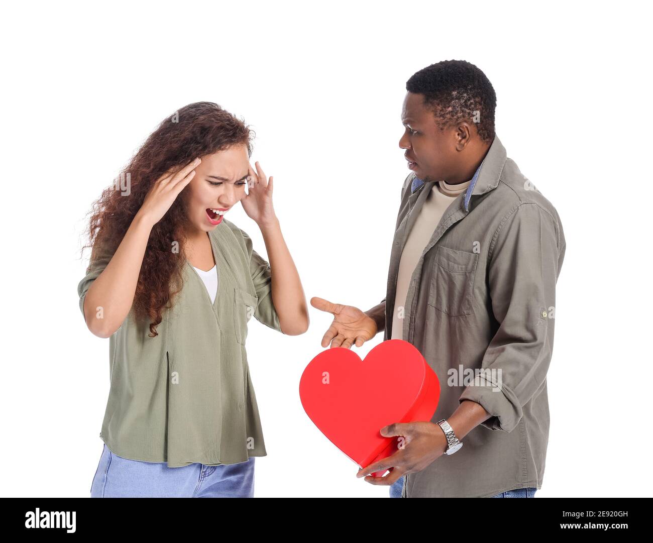 Confused African-American man greeting his angry girlfriend on ...