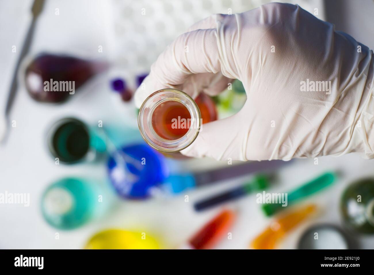 Top view of Erlenmeyer flask with red liquid chemical elements in the ...