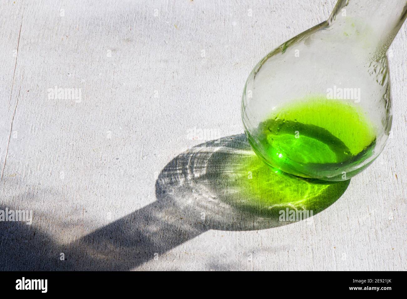 Laboratory glassware with green color reagent with shadows and ...