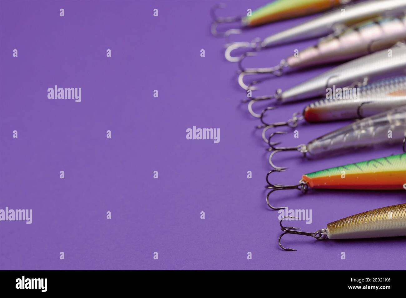 Artificial lures for fishing for predatory fish on a blue background ...