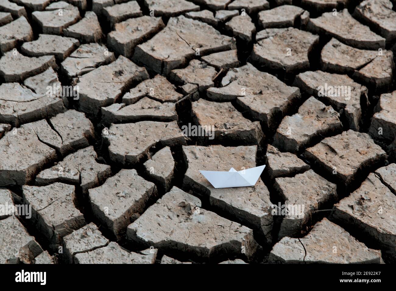 Paper boat on dry lake, conceptual drought, global warming Stock Photo ...