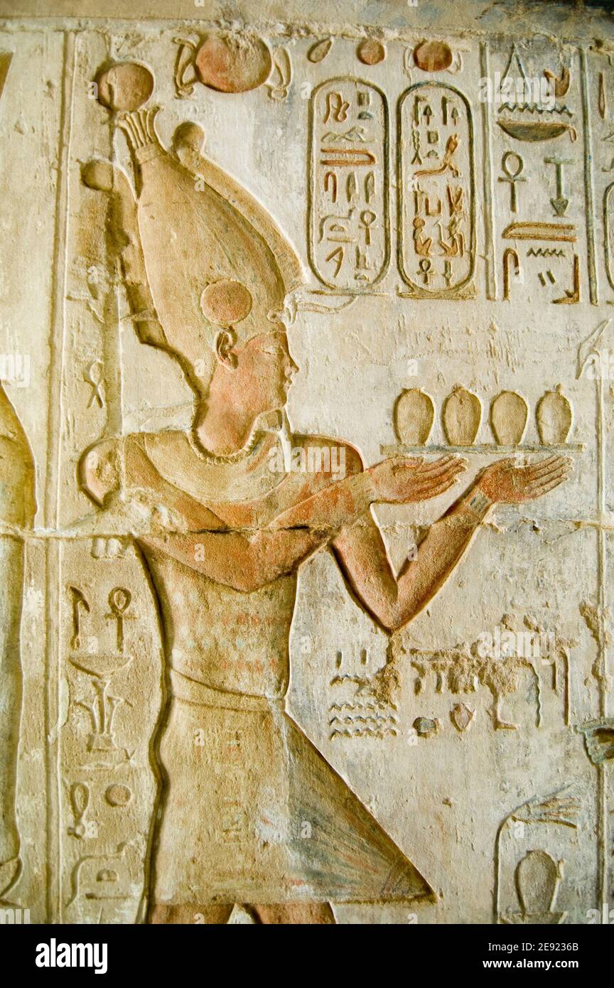 Ancient Egyptian bas relief carving of Pharaoh Ptolemy IV making an ...