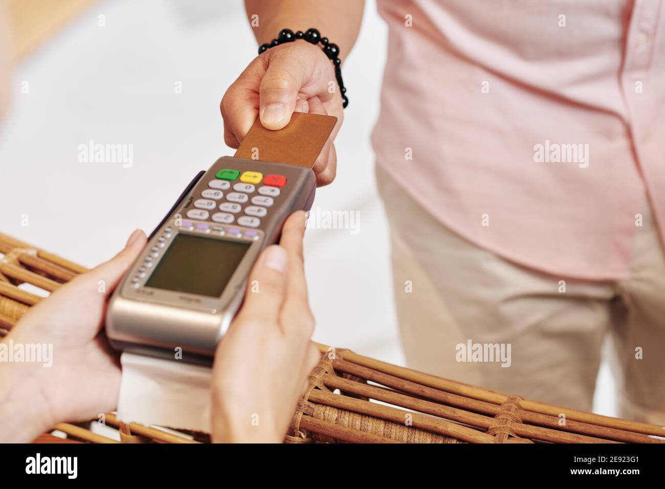Spa hotel guest paying with card Stock Photo - Alamy