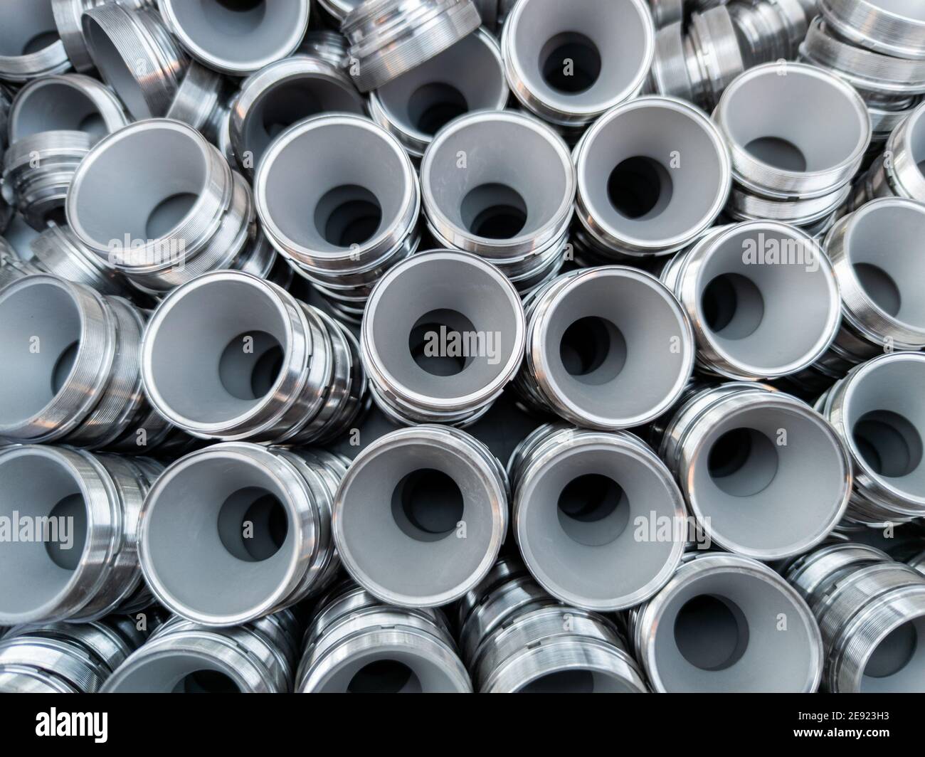full frame industrial background of turned shiny round steel parts with ...