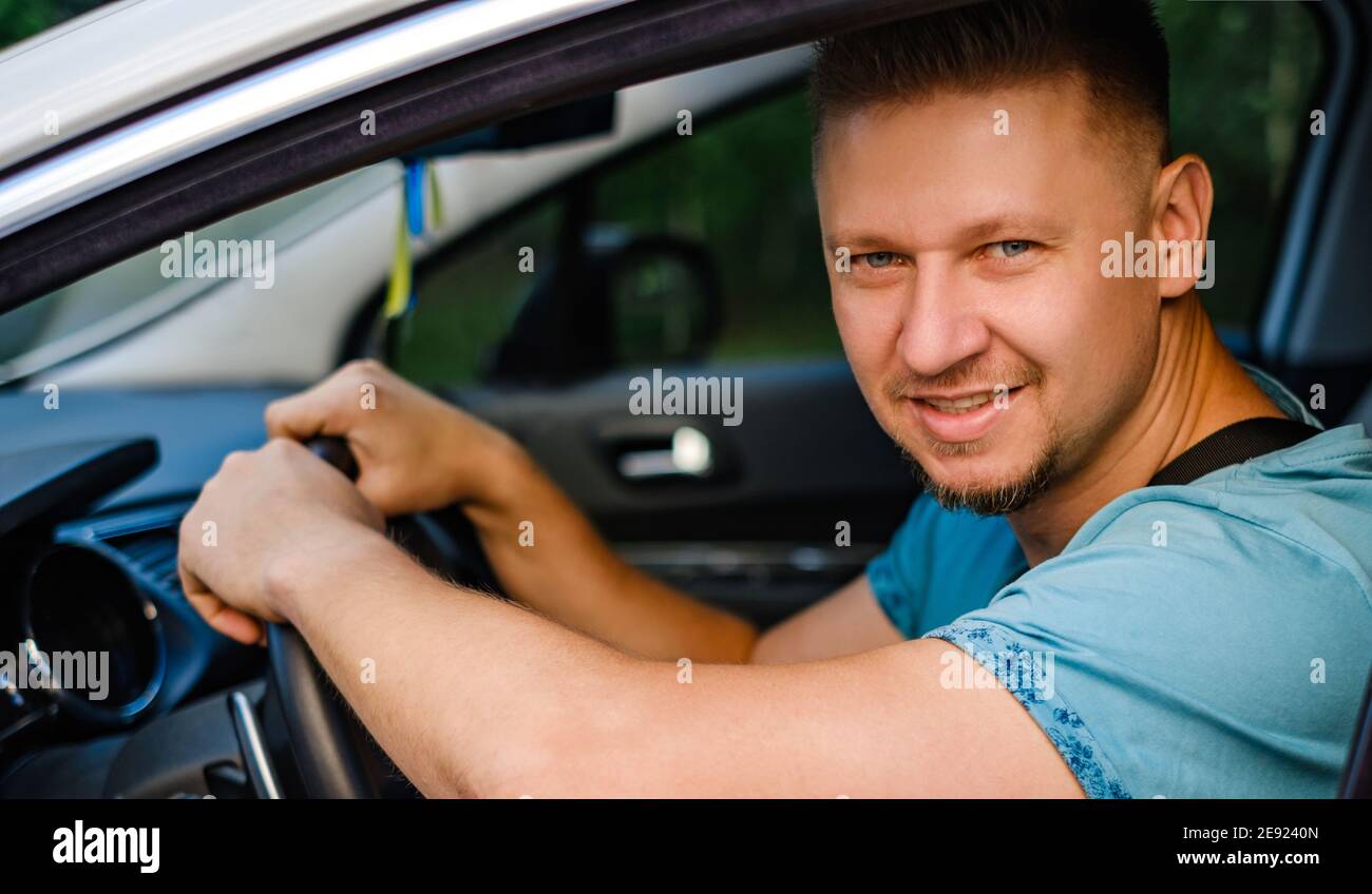 Young attractive man in white car, outdoors Stock Photo - Alamy