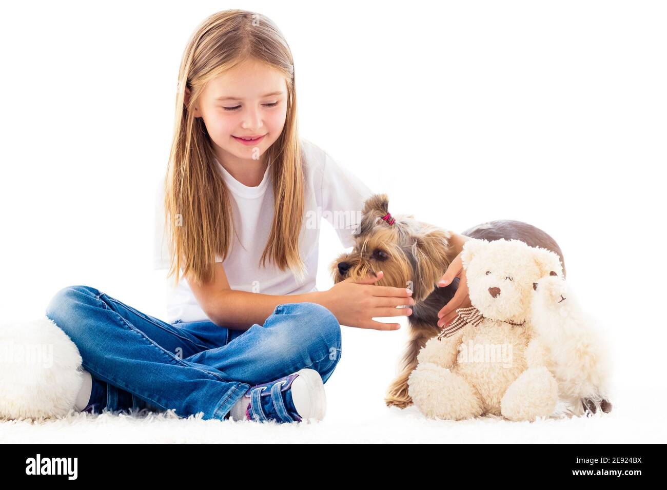 Little girl catching small dog in light room isolated on white Stock ...