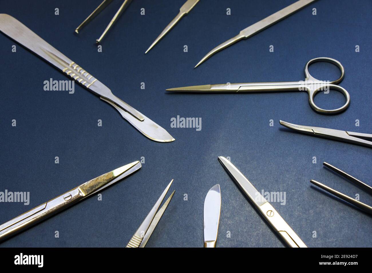 Top view of set of stainless dissecting kits against blue background ...