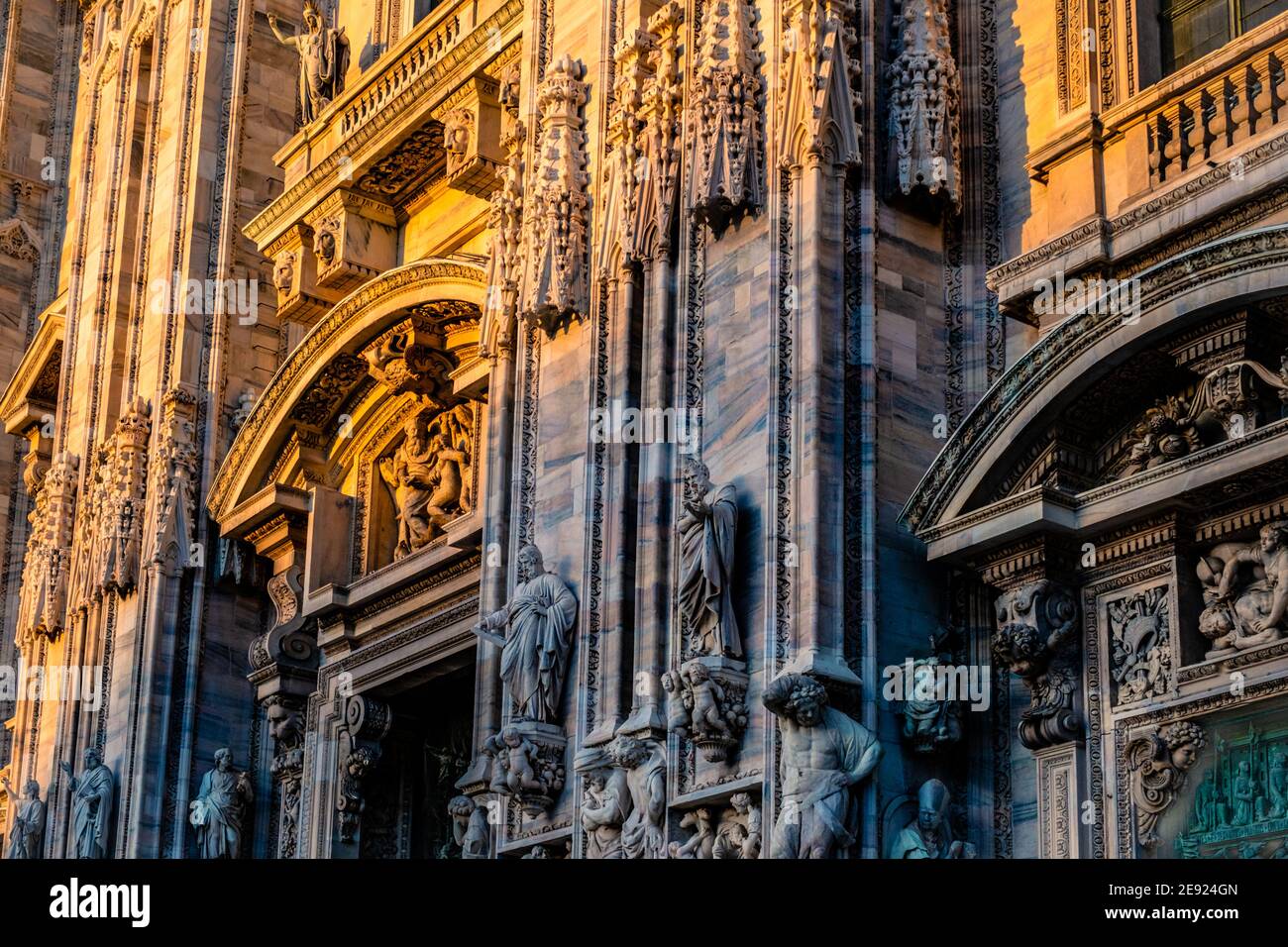 Statues on Milan Duomo facade in sunset light Stock Photo - Alamy