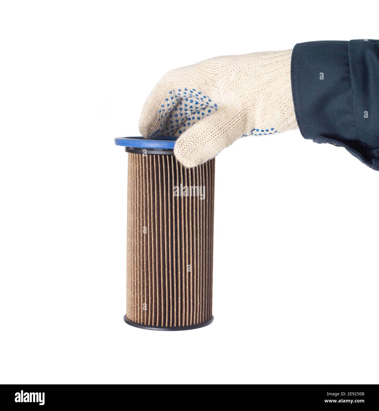 An auto mechanic holds an old dirty fuel filter in his hand. Fuel ...