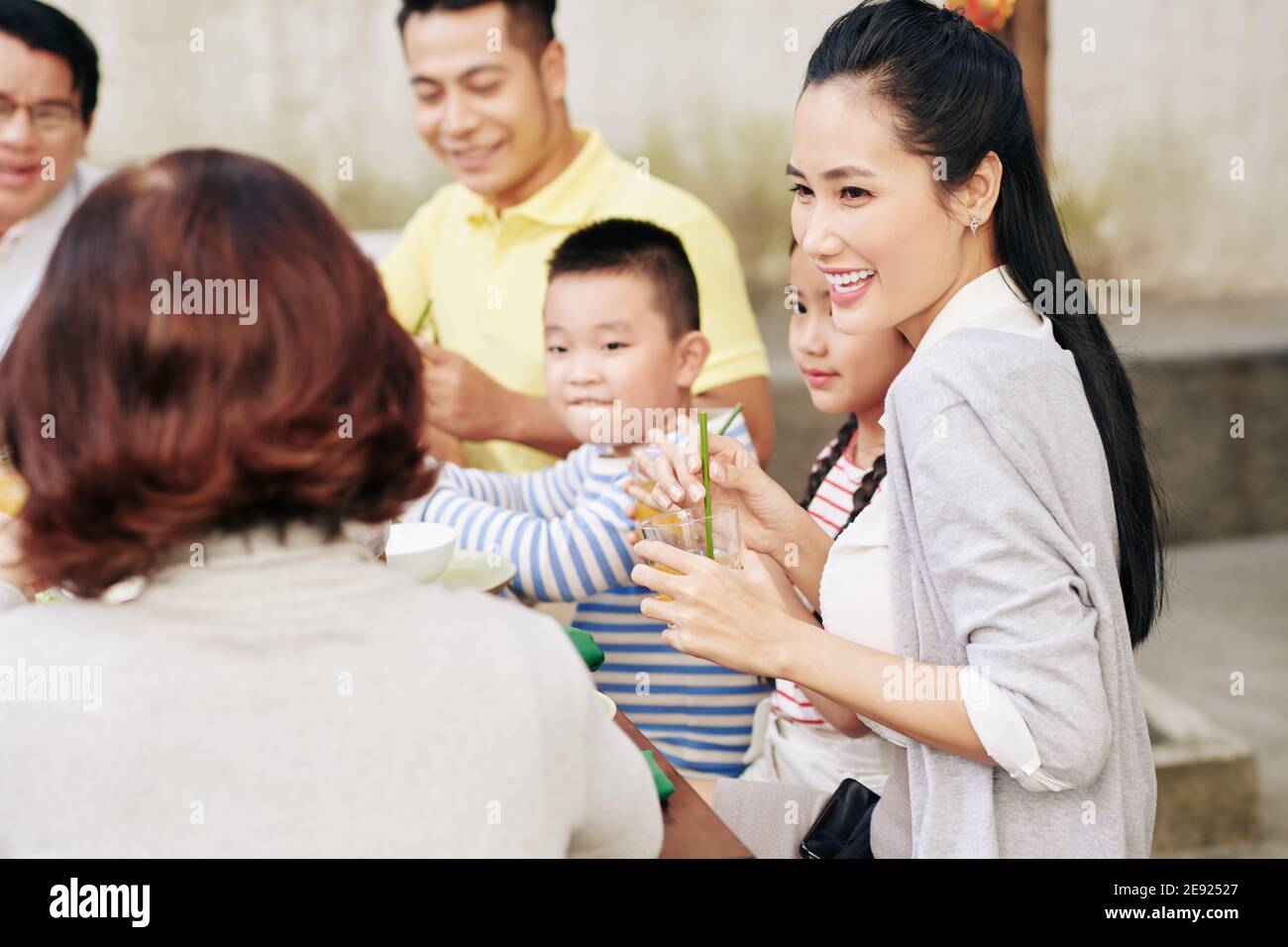 Woman talking to family members Stock Photo - Alamy