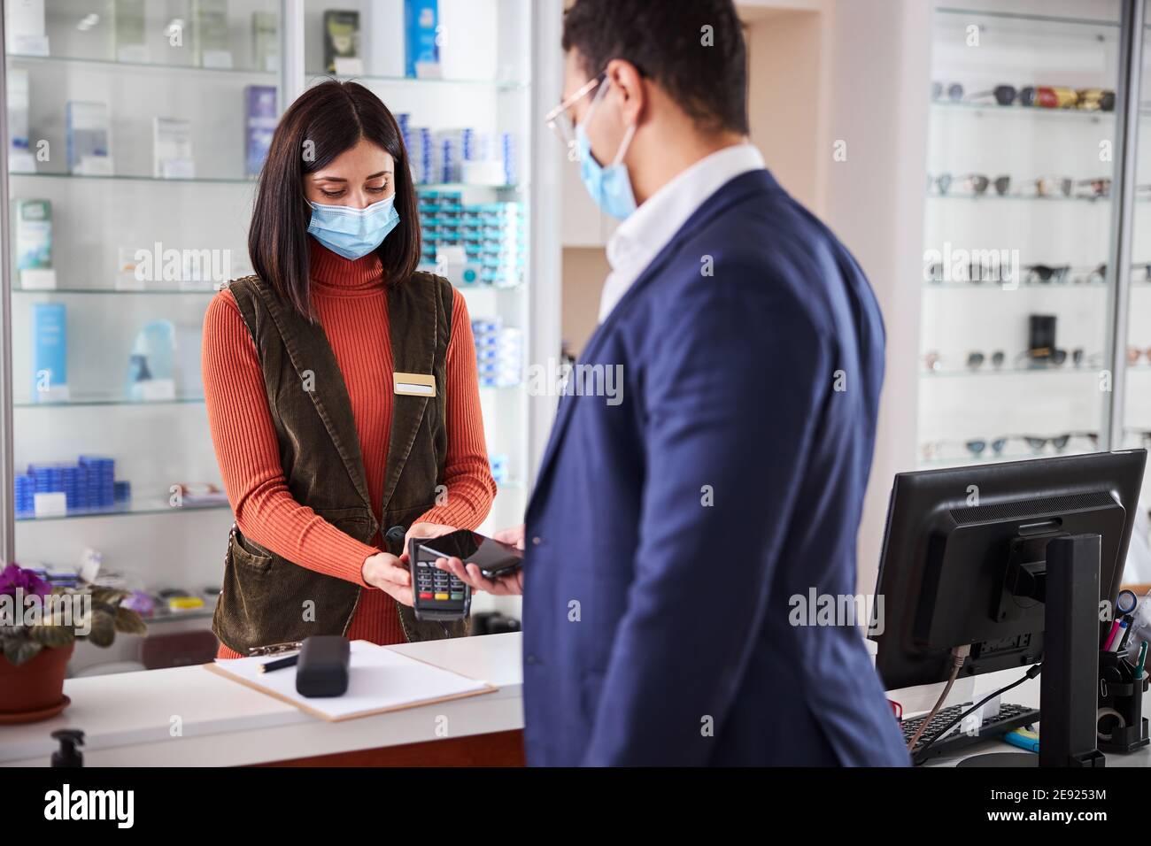 Buyer paying with his smartphone at a store checkout counter Stock ...