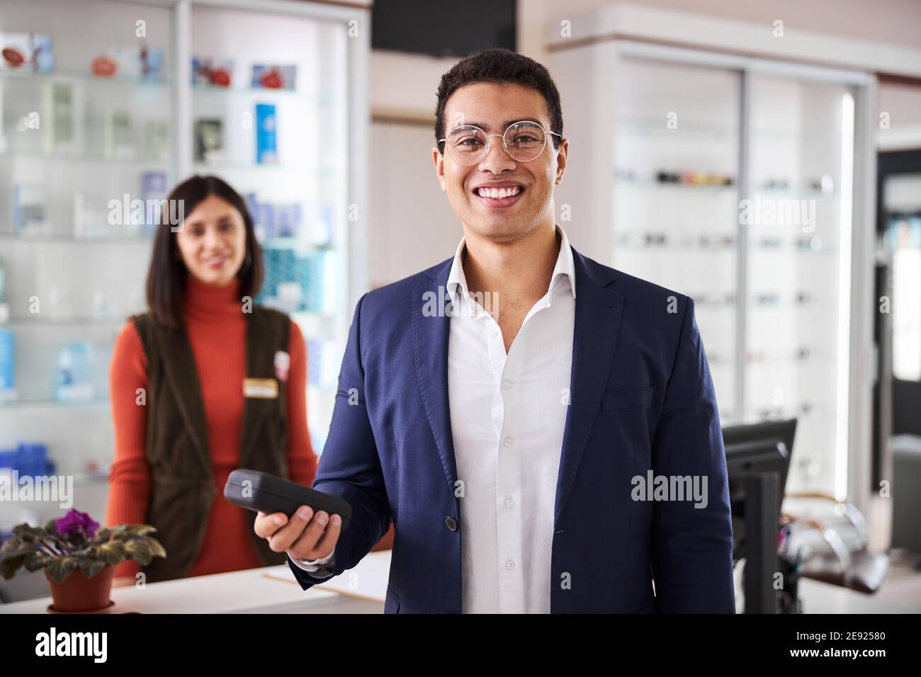 High-spirited customer holding a spectacle case in one hand Stock Photo ...