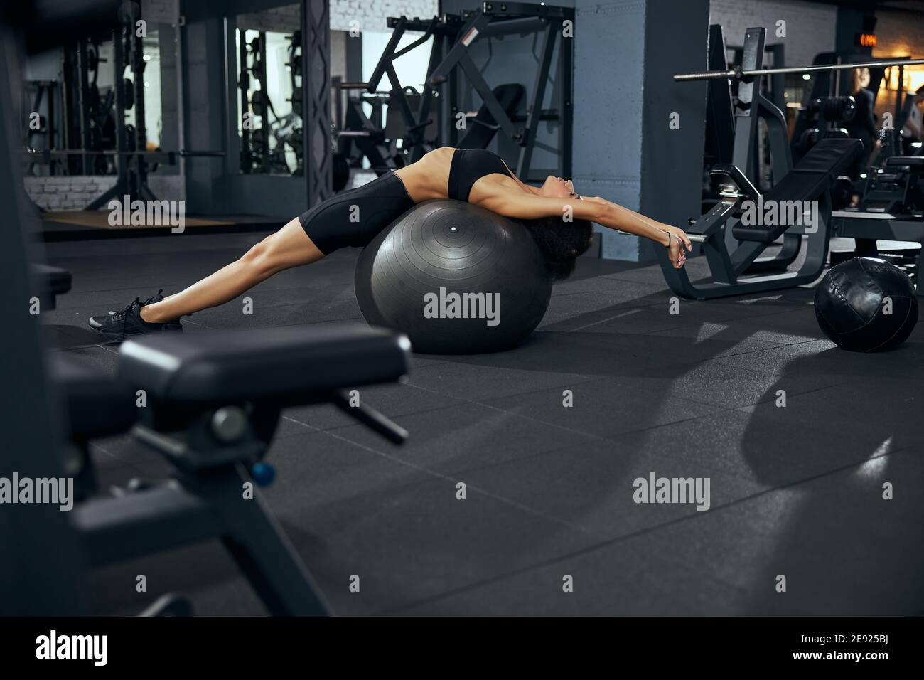 Slim international woman stretching her back and arms Stock Photo - Alamy