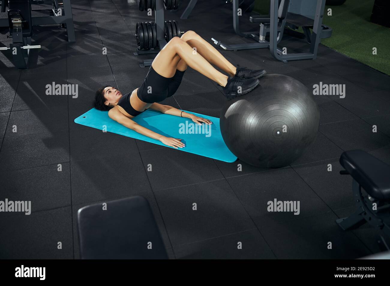 Strong young woman keeping her body in tonus Stock Photo - Alamy