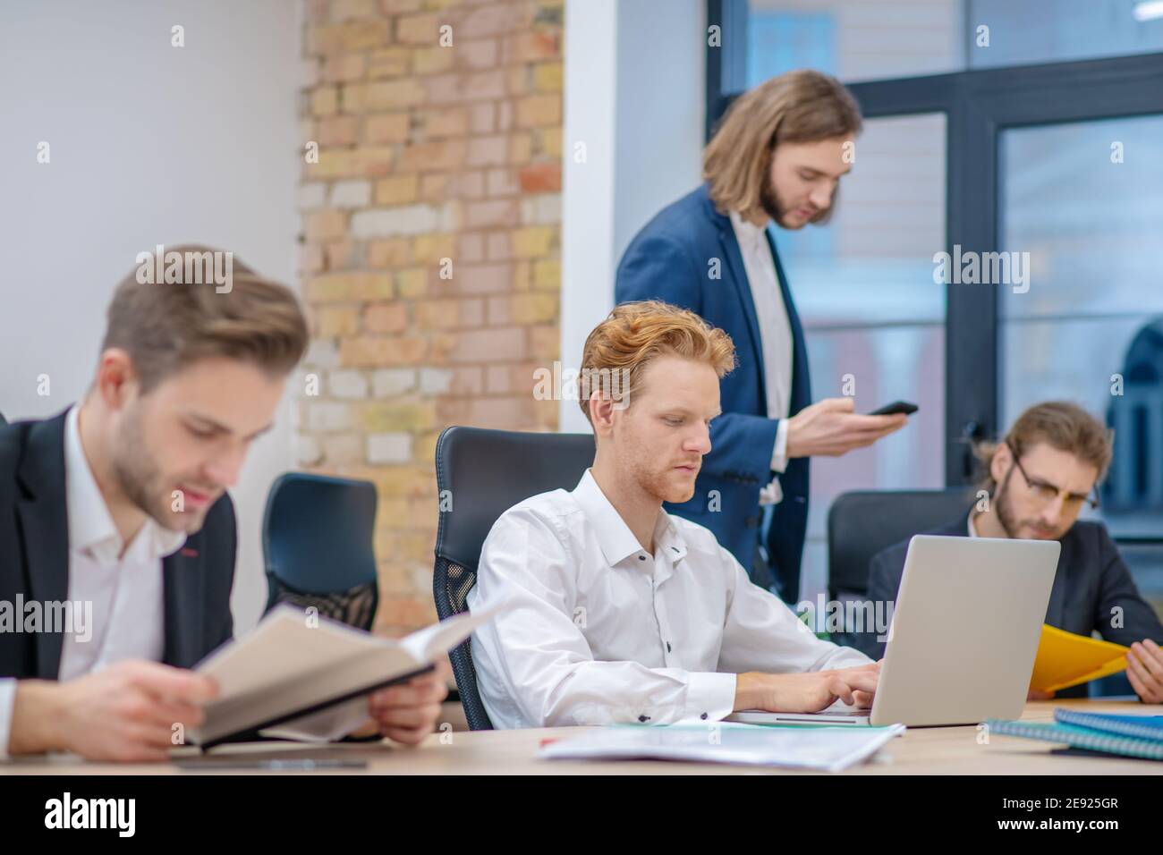 Group of men concentratedly busy in office Stock Photo - Alamy