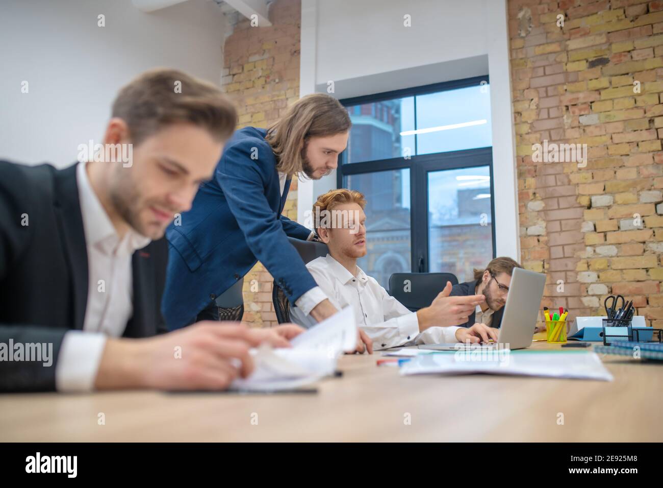 Young men in the office during work Stock Photo - Alamy