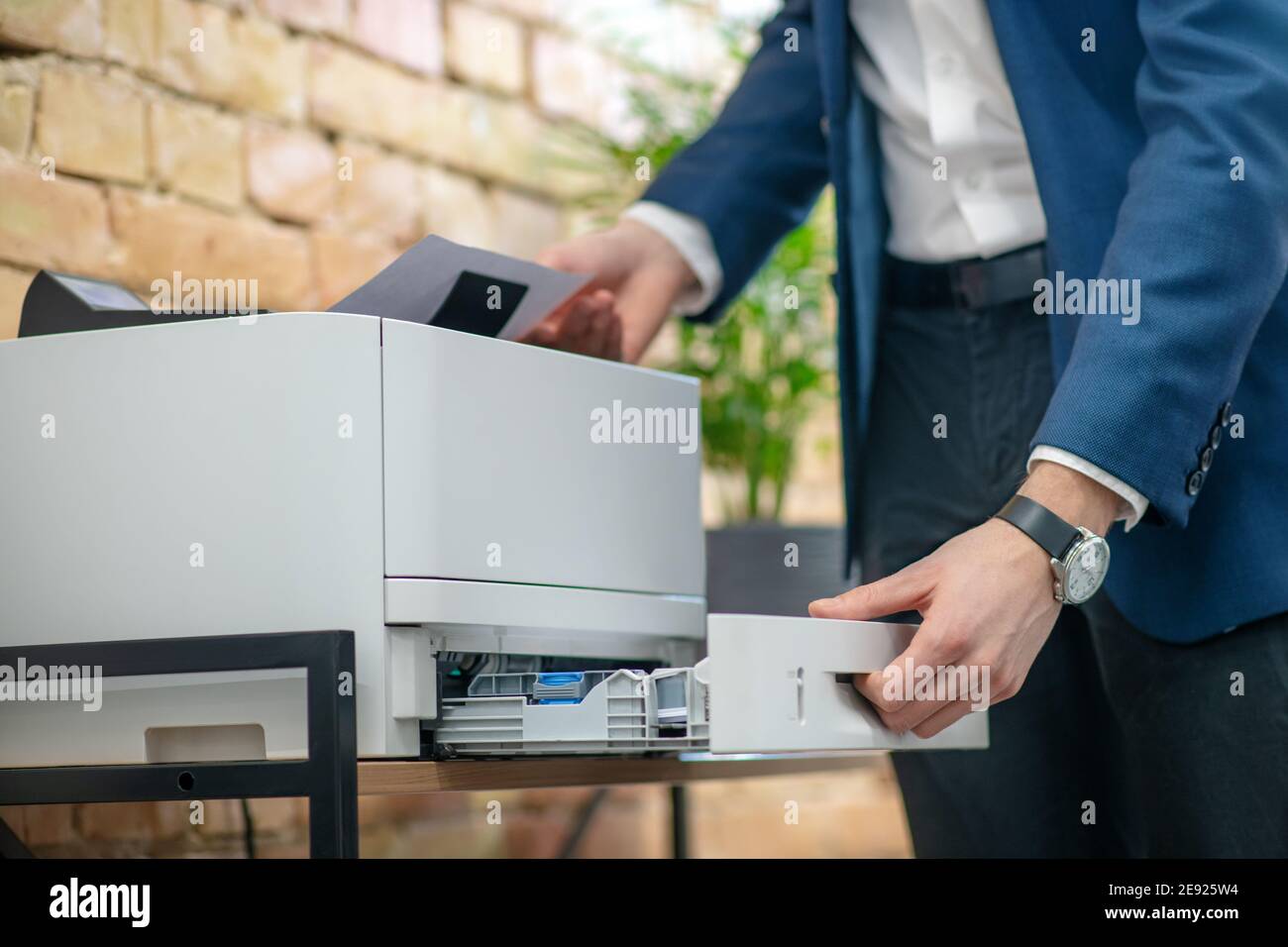 Man hand opening container in gadget in another paper Stock Photo - Alamy
