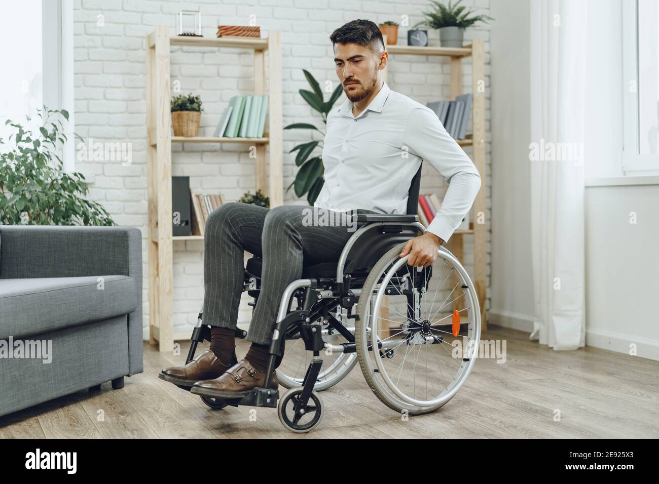 Portrait of disabled man in formal wear sitting in a wheelchair Stock ...