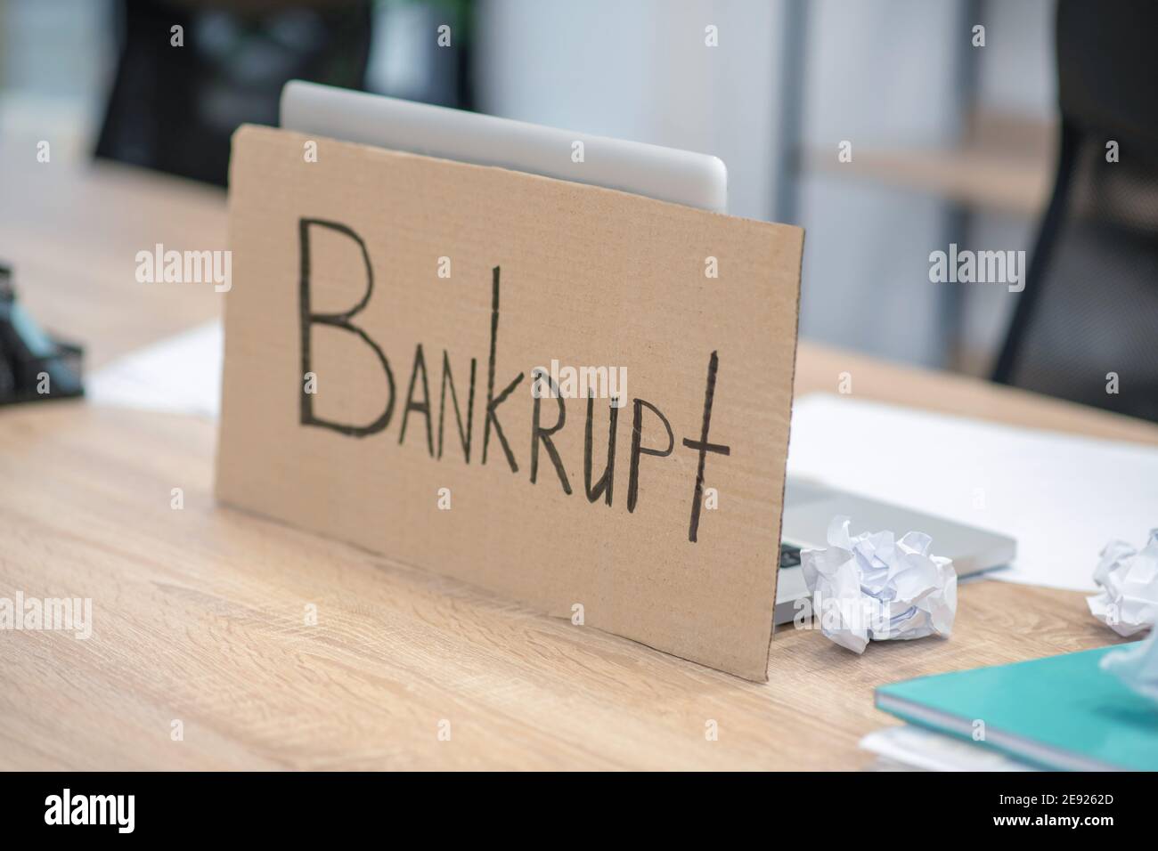 Poster near laptop on table in office Stock Photo - Alamy