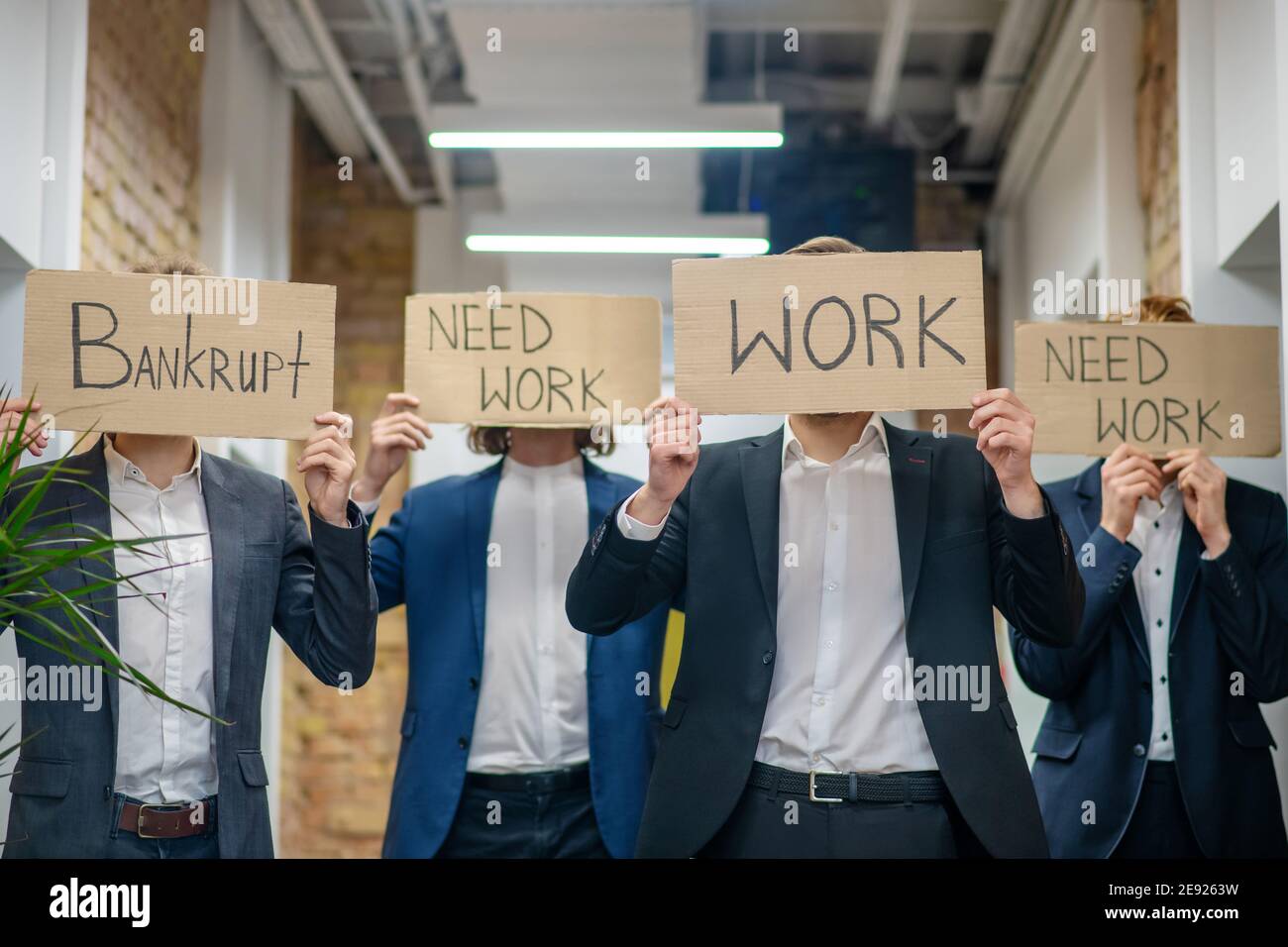 Men with posters demanding work standing indoors Stock Photo - Alamy
