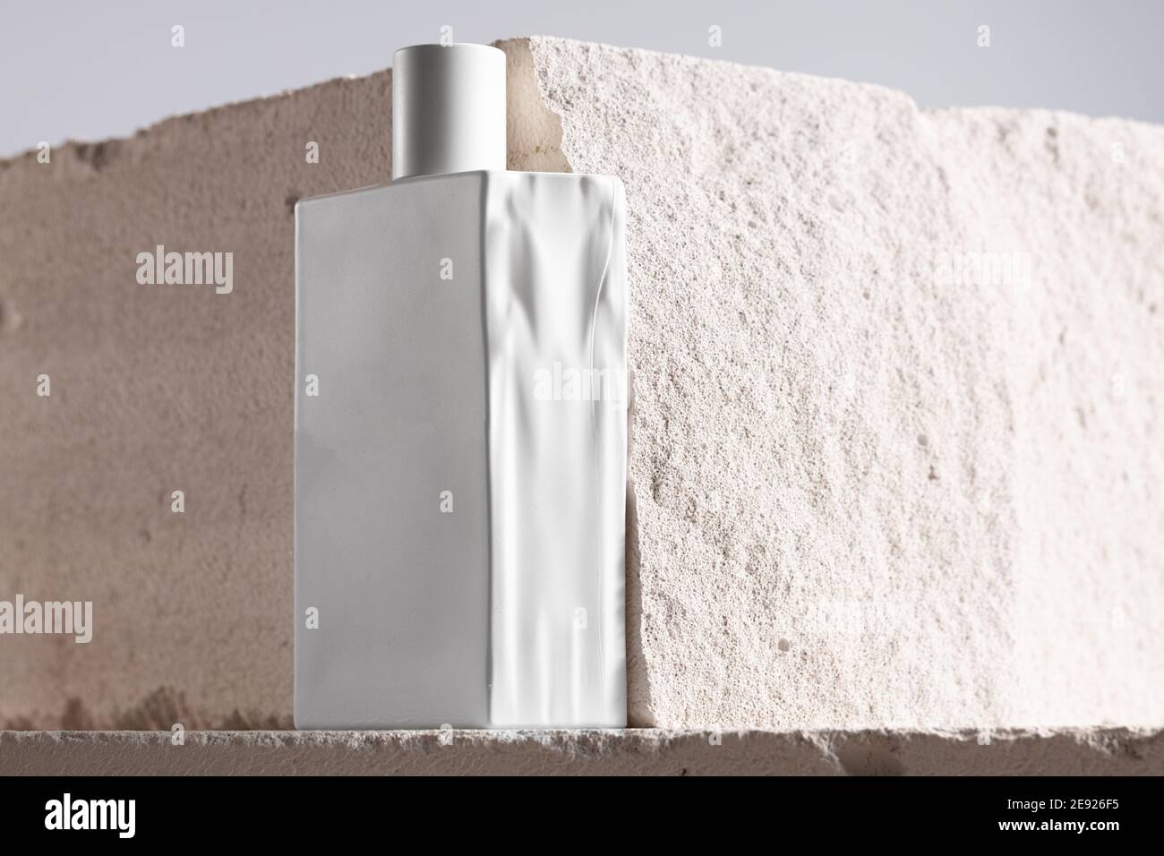 Bottle of perfume on cinder block close up Stock Photo - Alamy