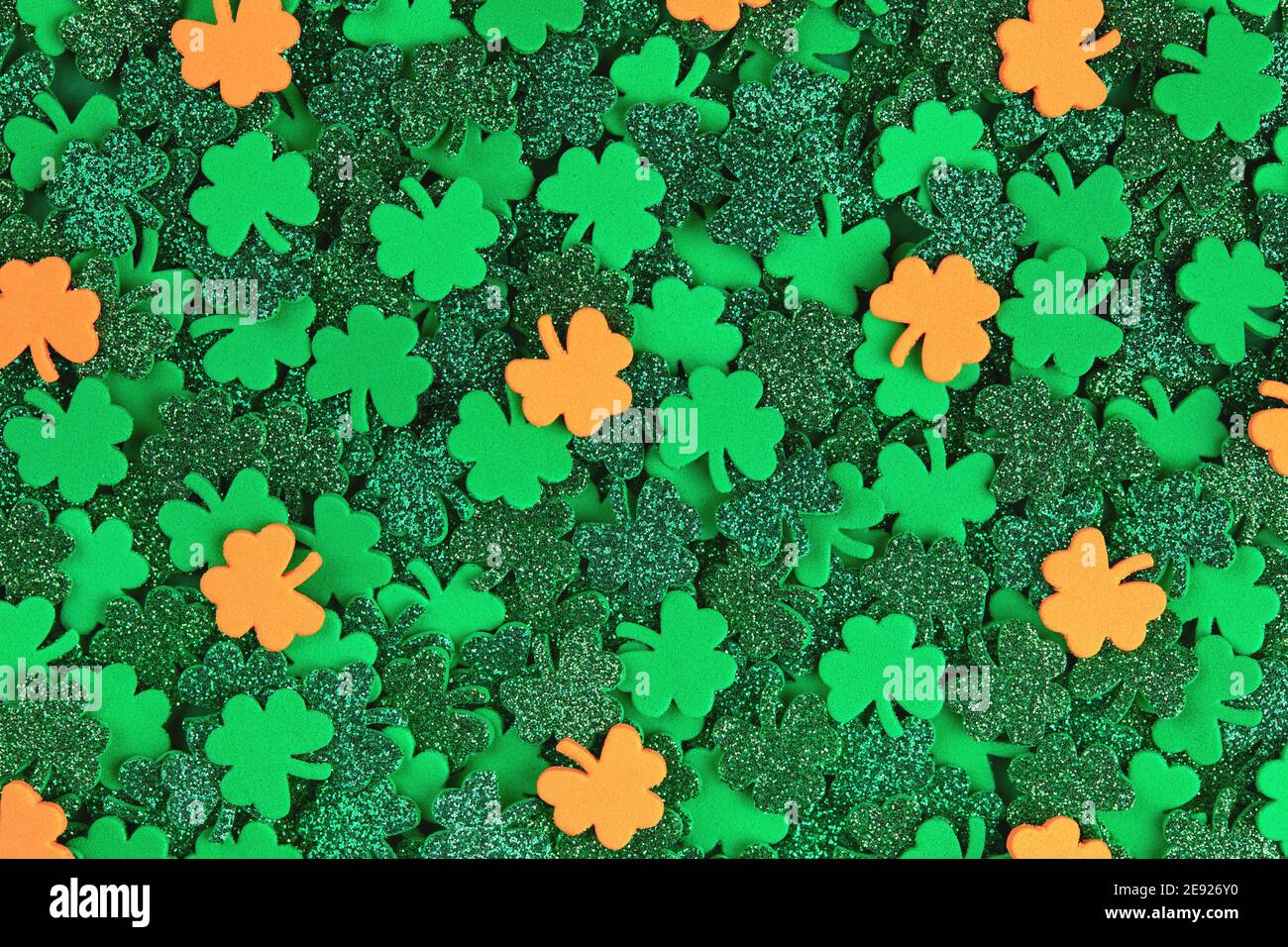 Shamrock confetti texture background with green and orange lucky ...