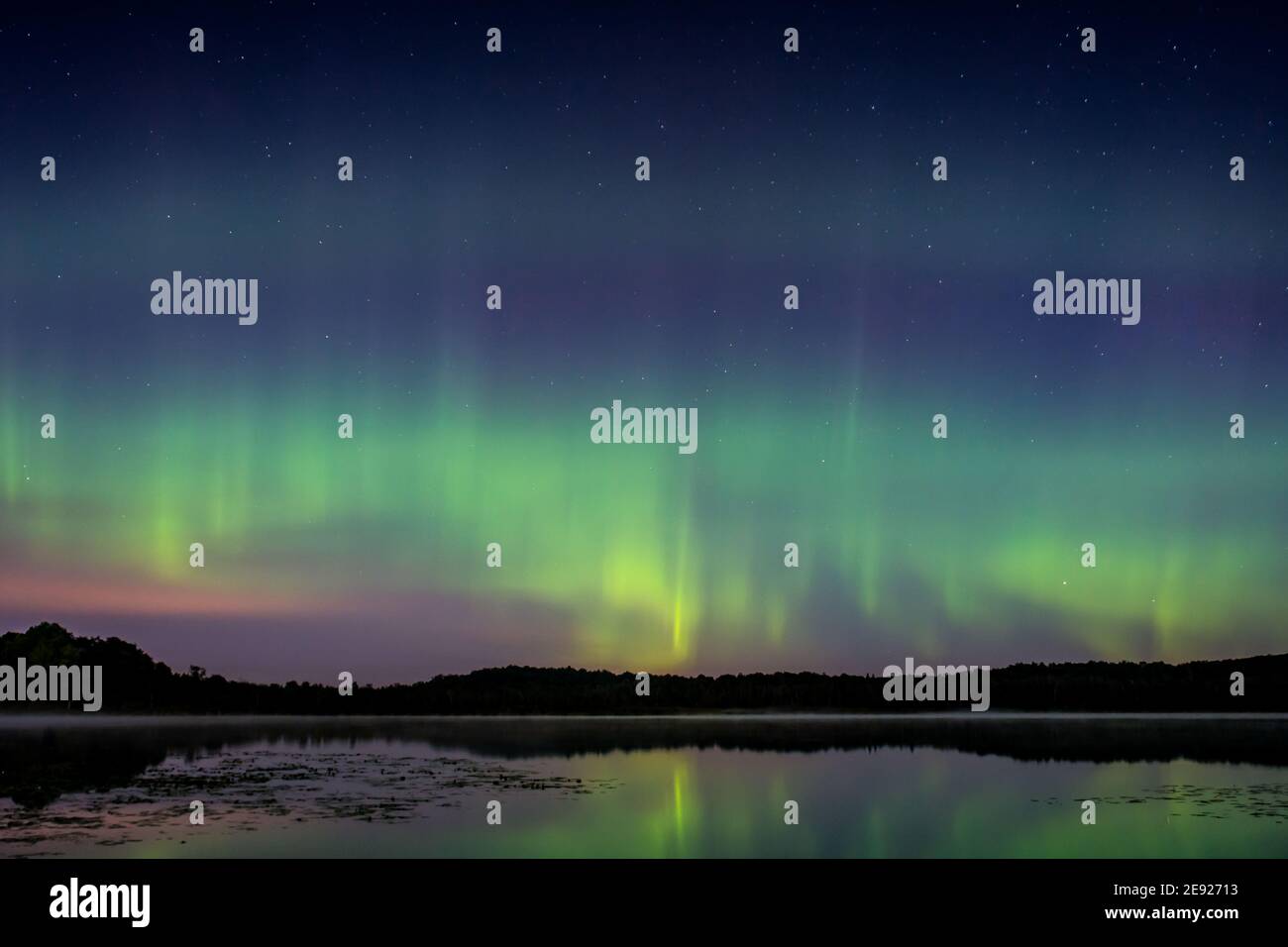 The northern lights, aurora borealis over a lake in Wisconsin Stock ...