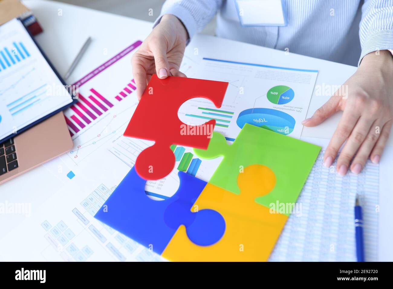 Business woman folding colorful puzzle over documents closeup Stock ...