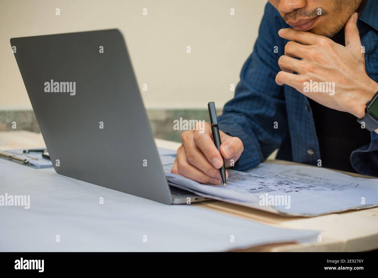 Engineer check drawing blueprint to work for building construction ...