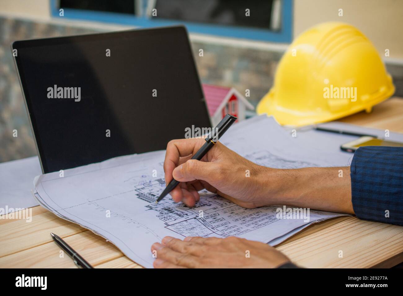 Engineer check drawing blueprint to work for building construction ...