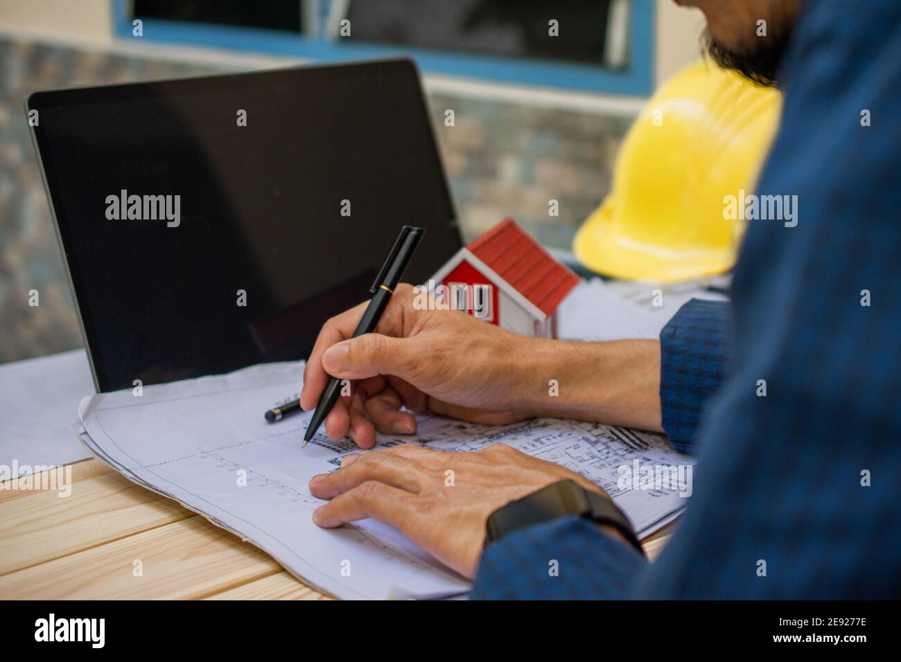 Engineer check drawing blueprint to work for building construction ...