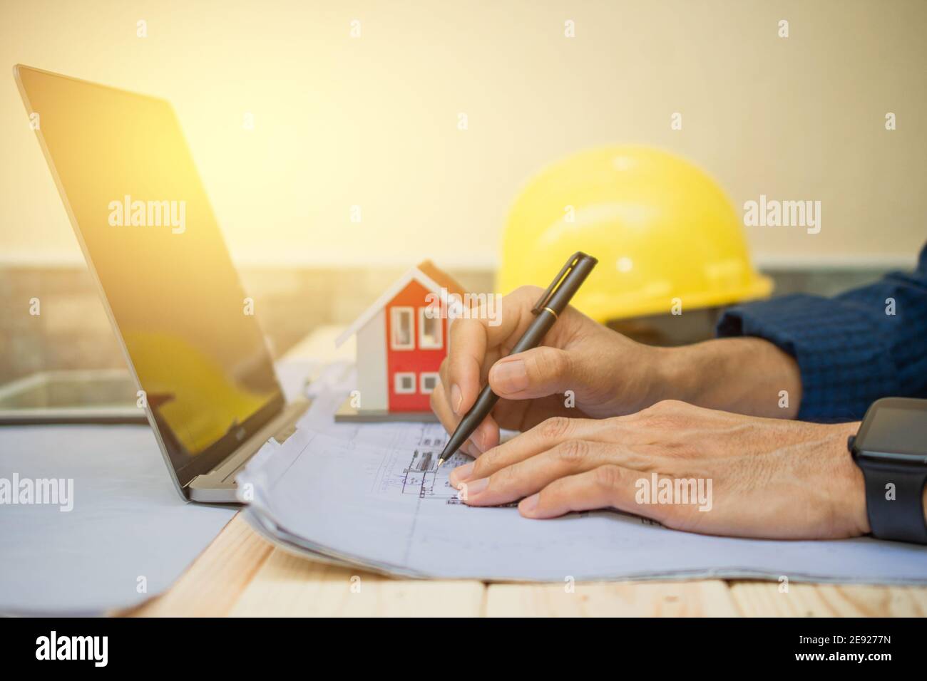 Engineer check drawing blueprint to work for building construction ...
