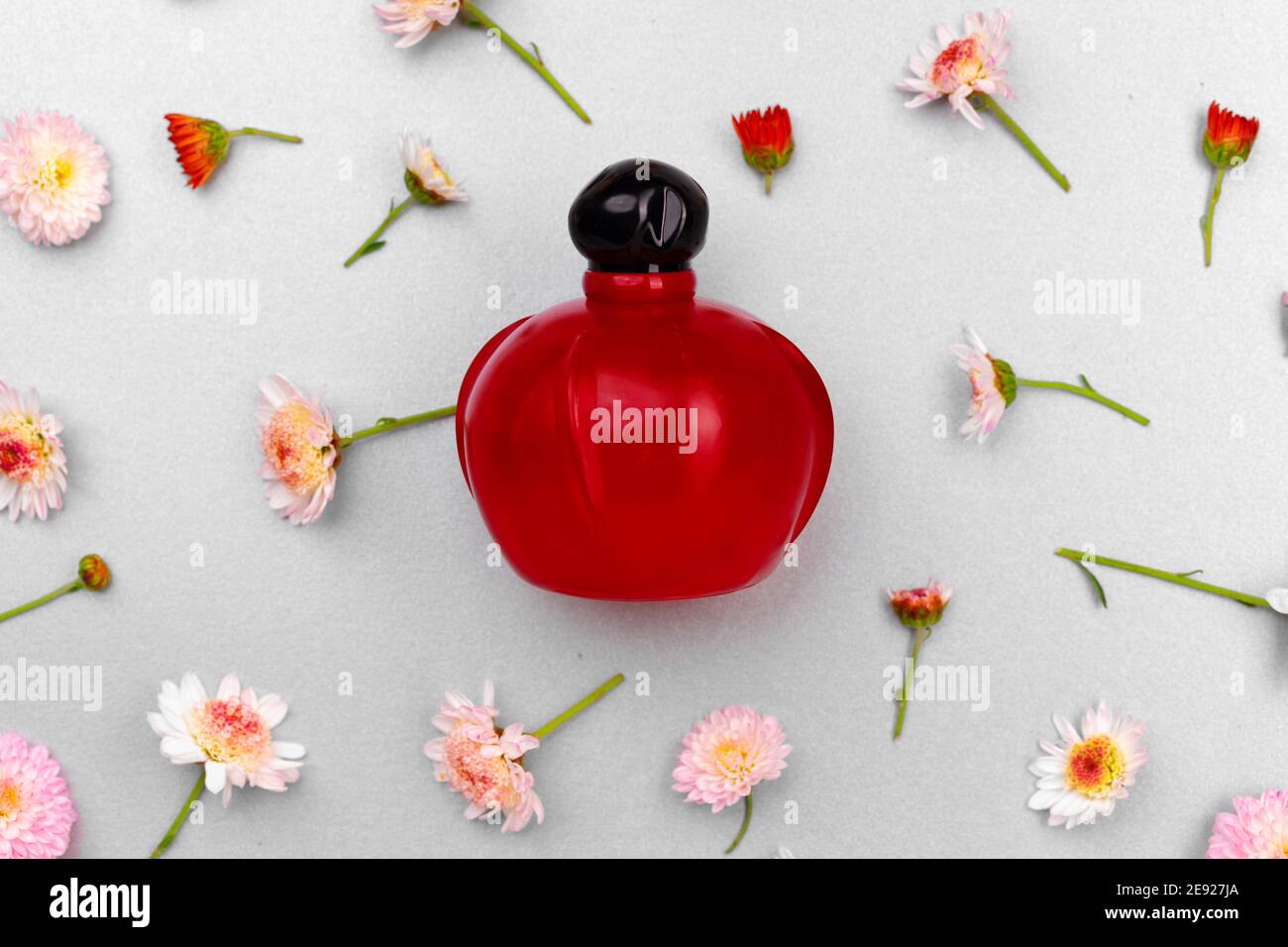 Bottle of fragrance surrounded by flower buds Stock Photo - Alamy
