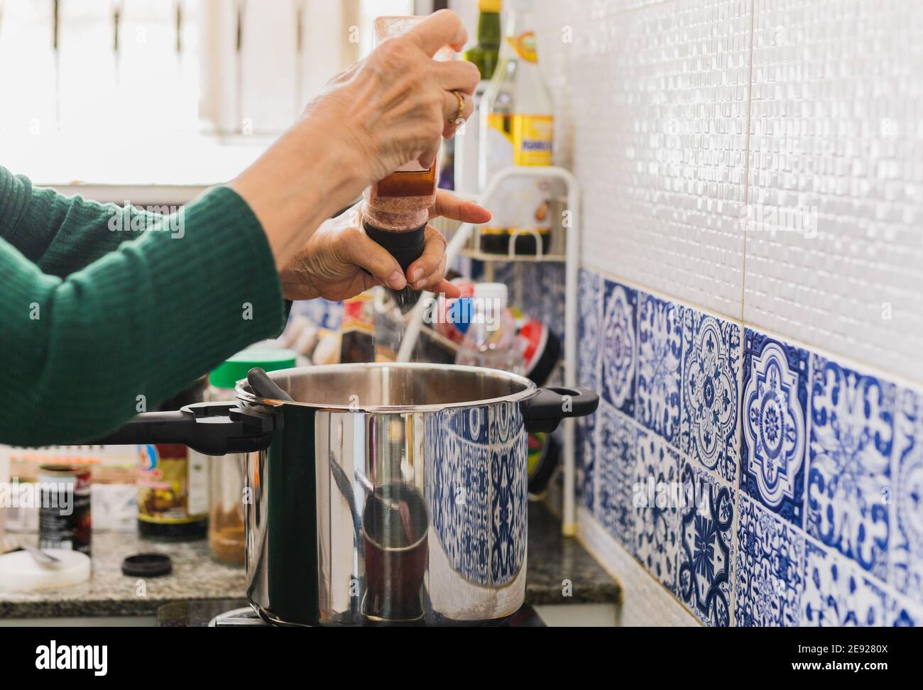 Woman adding salt to food hi-res stock photography and images - Alamy