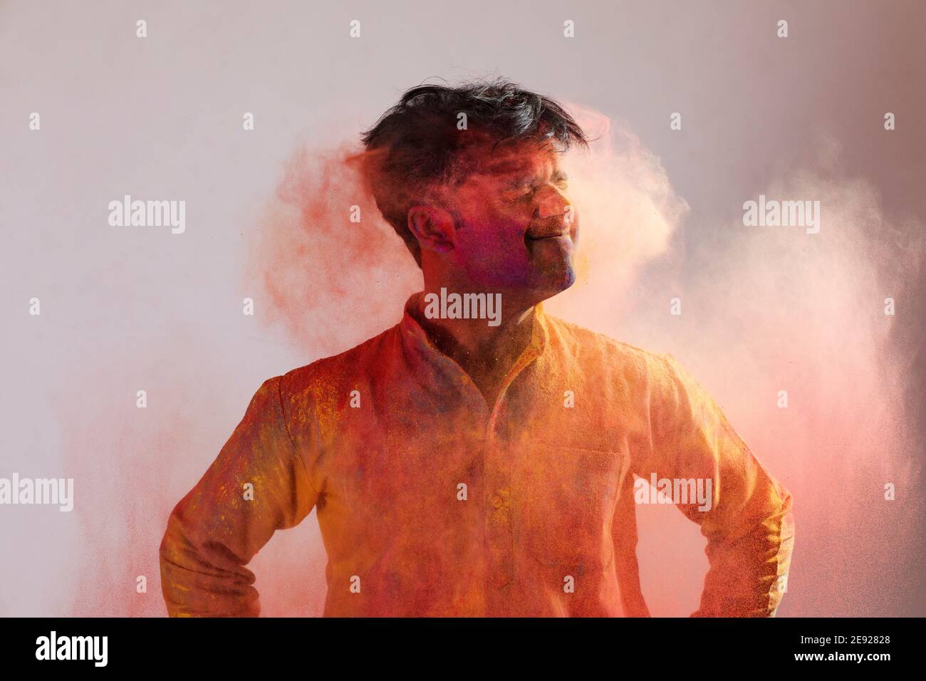Man shaking his head to get the color out of his hair on Holi Stock ...