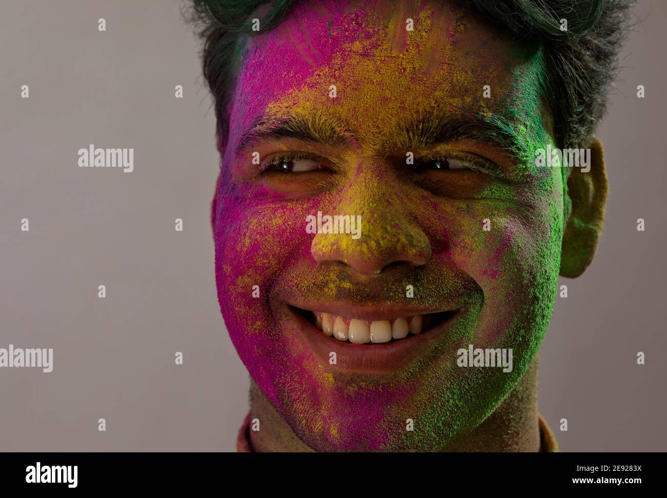 Young man looking sideways with a mischievous smile on his face Stock ...