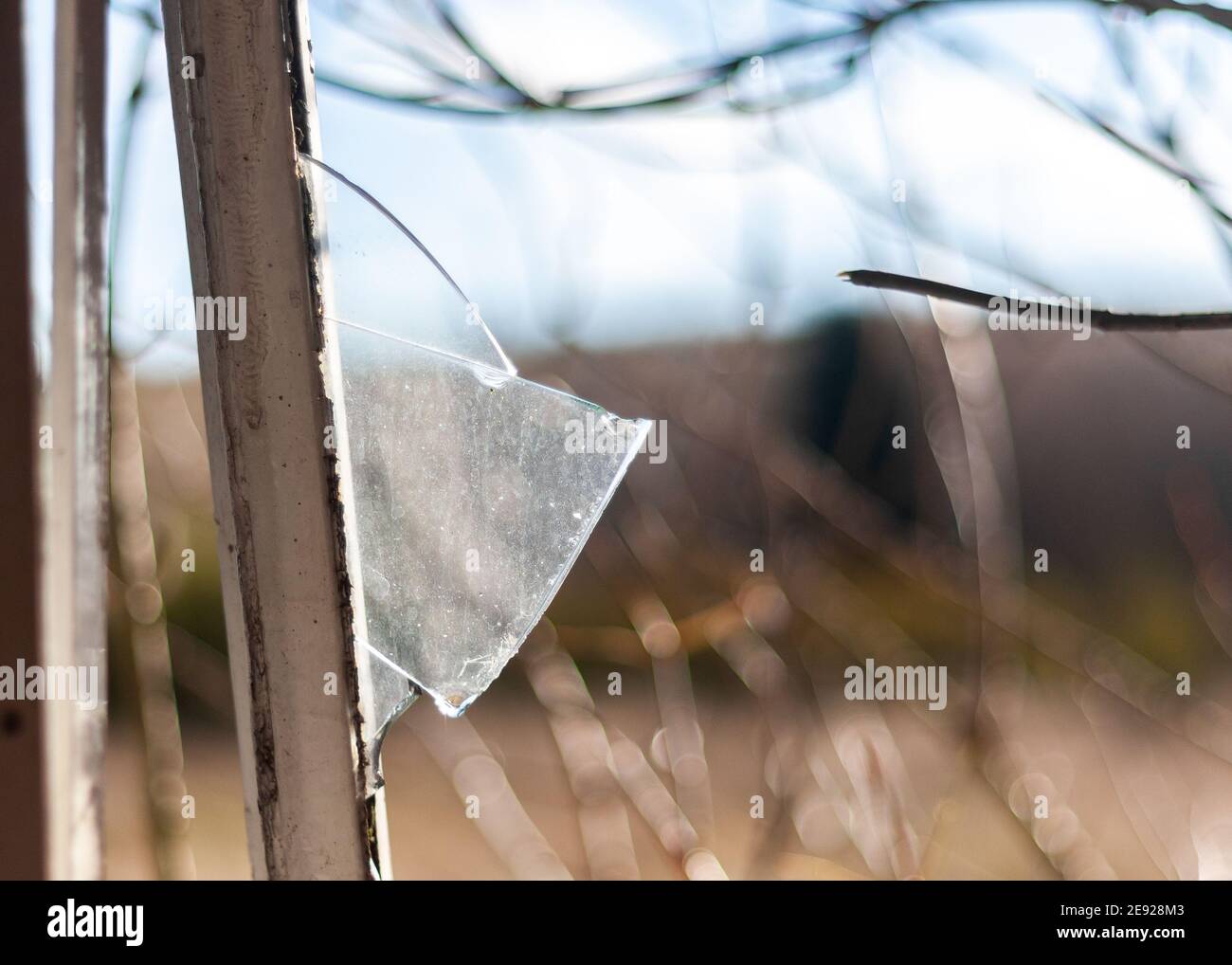 Broken glass following burglary in open window with metal frame sharp ...