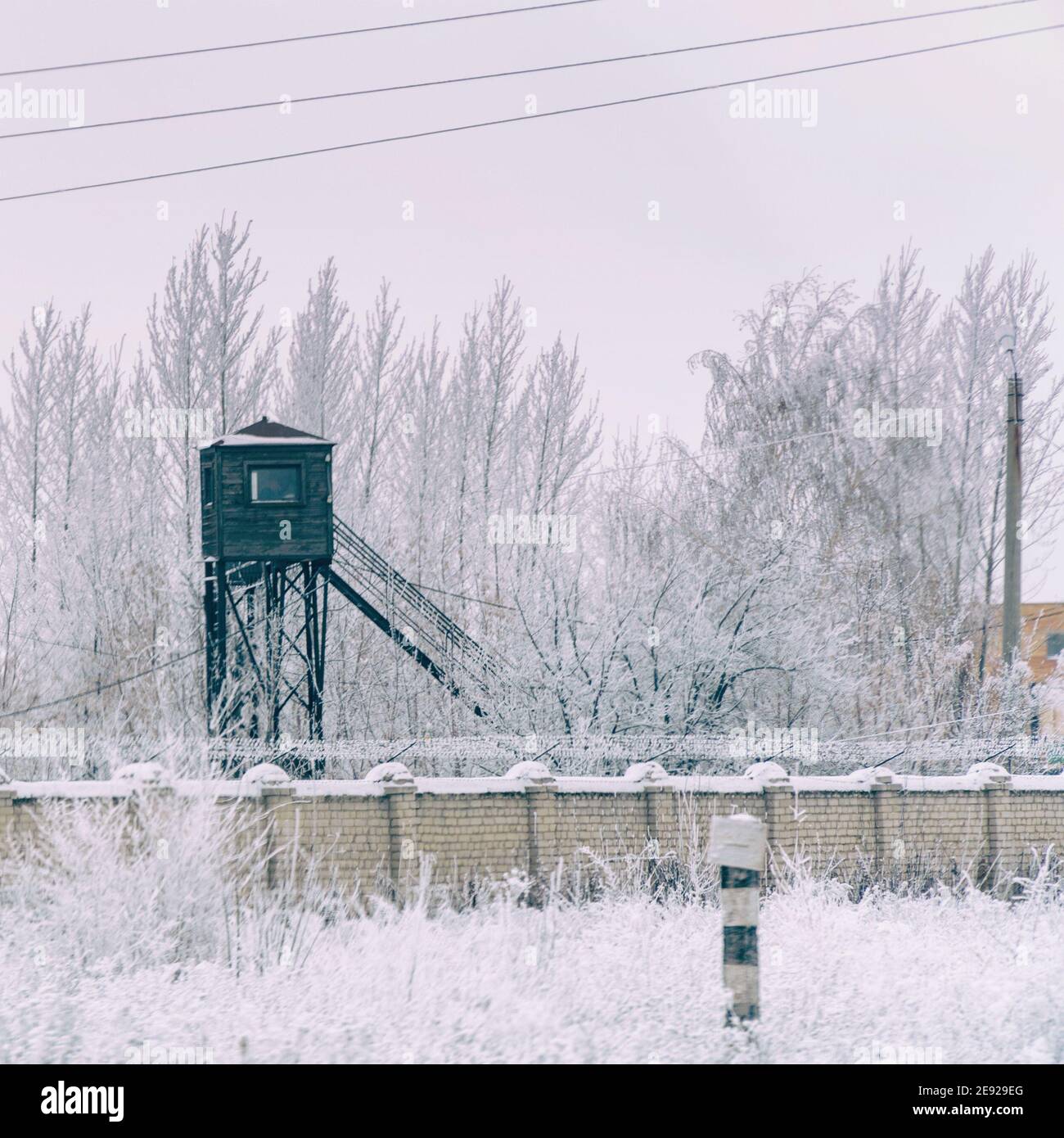 Prison tower at the fence with barbed wire. in winter in the snow Soft ...