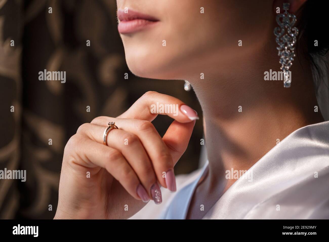Gentle female hands of the bride with a gold wedding ring on the ring ...