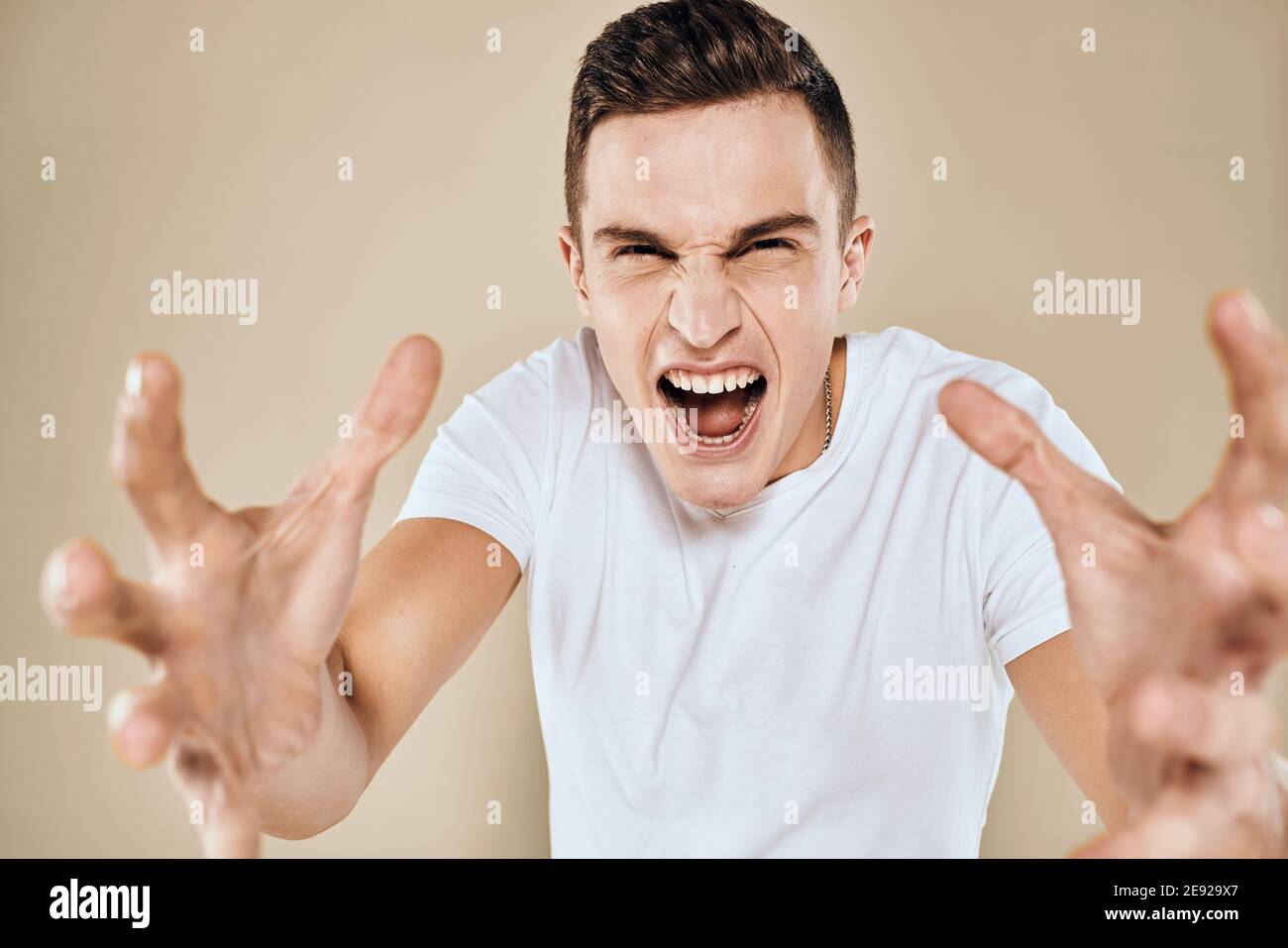 Man with displeased facial expression emotions white t-shirt gestures ...
