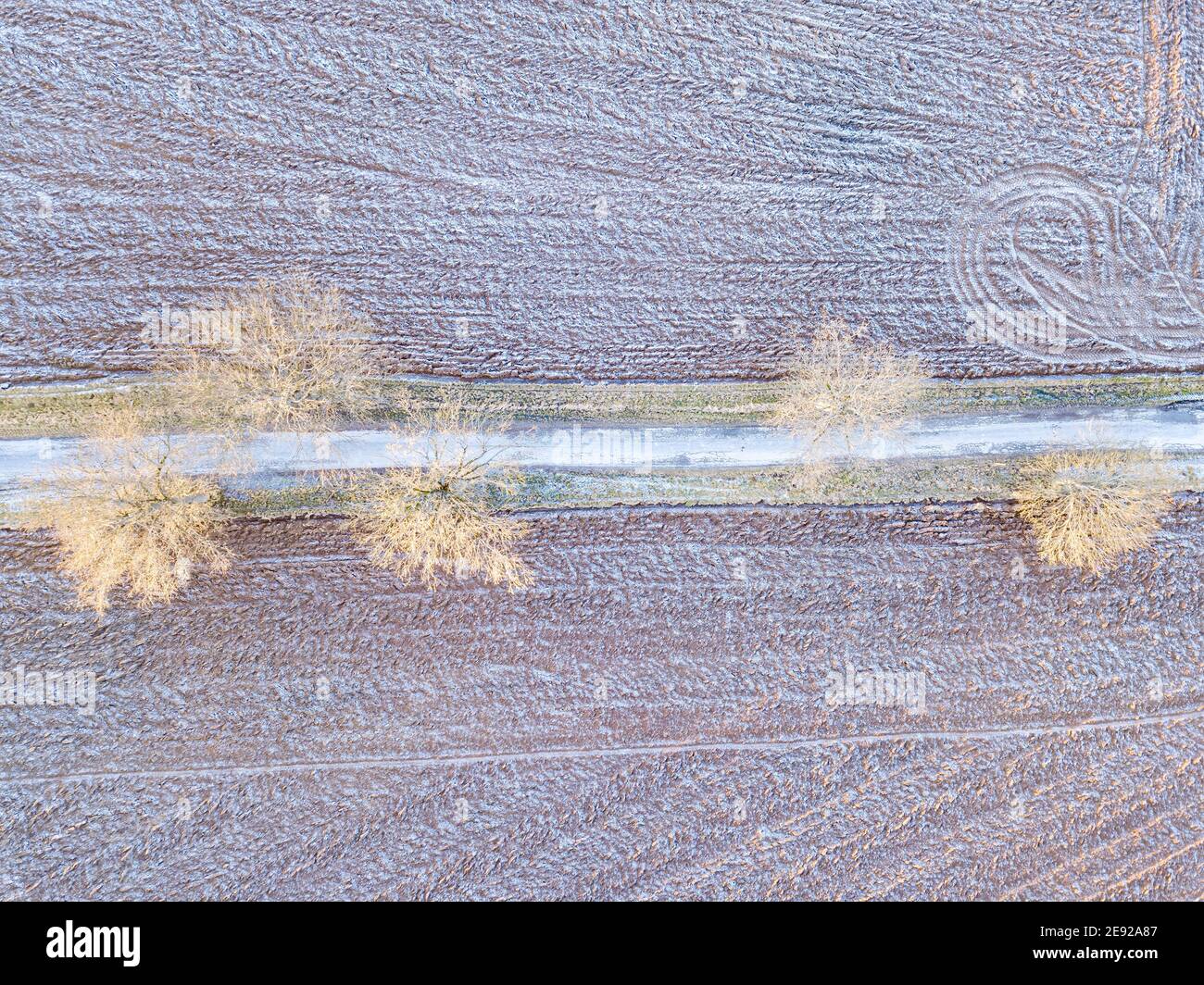 winter road, landscape covered by morning frost, top down aerial view ...