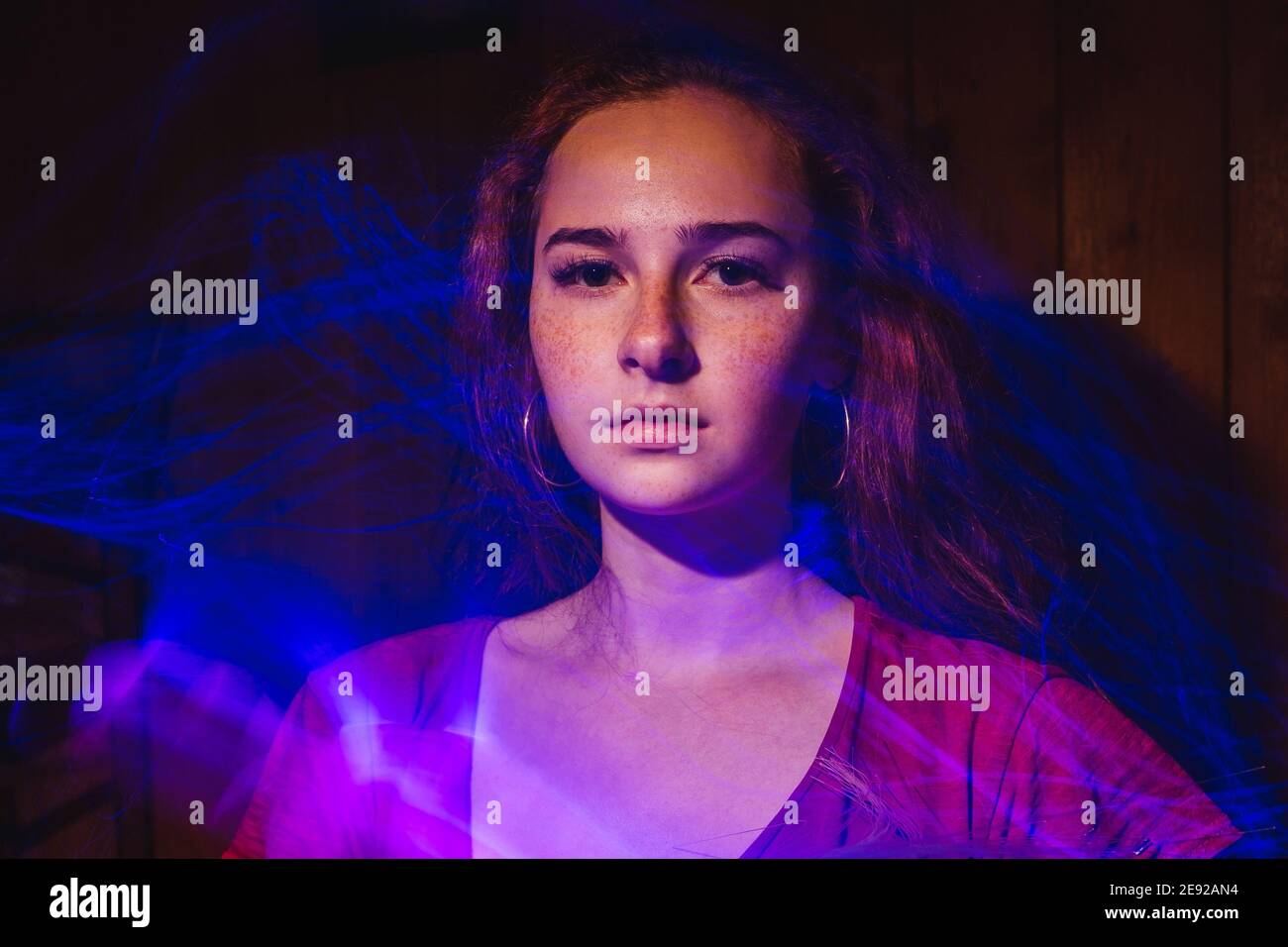 Strange portrait of beautiful cheerful redhead woman. Motion light ...